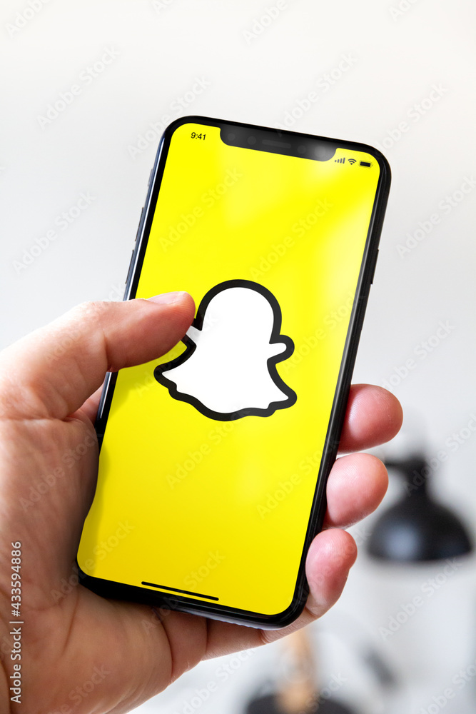 Hand holding iphone smartphone with Snapchat logo, Paris, France Stock ...