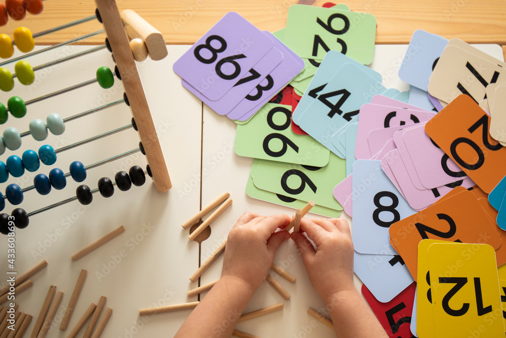 Little caucasian girl studying numbers and math in the classroom ...