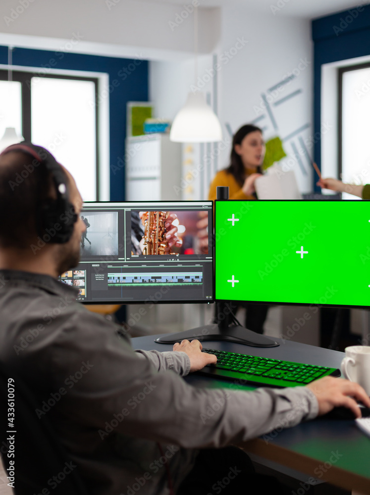 Video editor processing movie montage cutting footage at pc with green ...