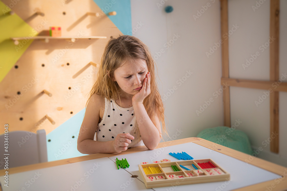 Caucasian girl learning to count at home in the classroom, preschool ...