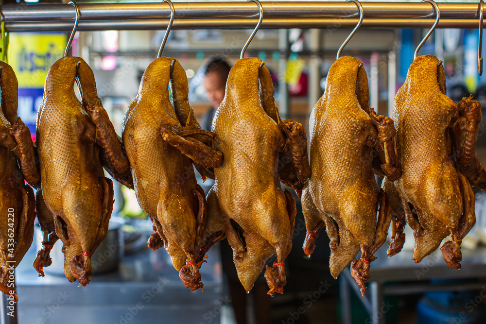 Spiced duck or Pot-stewed duck are hung by the stainless hooks in the ...