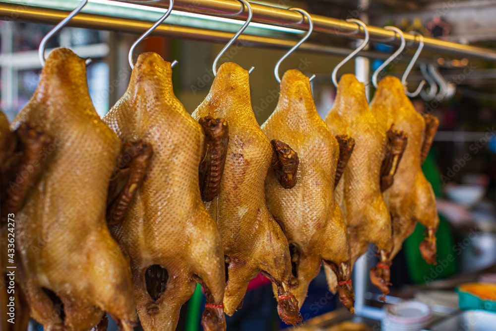 Spiced duck or Pot-stewed duck are hung by the stainless hooks in the ...