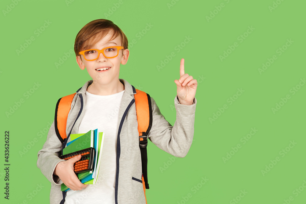 Cute student boy with school bag over green background. Happy kid in ...