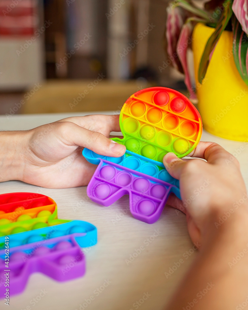 Young man playing with fidget sensory toy to relieve stress, simple way ...