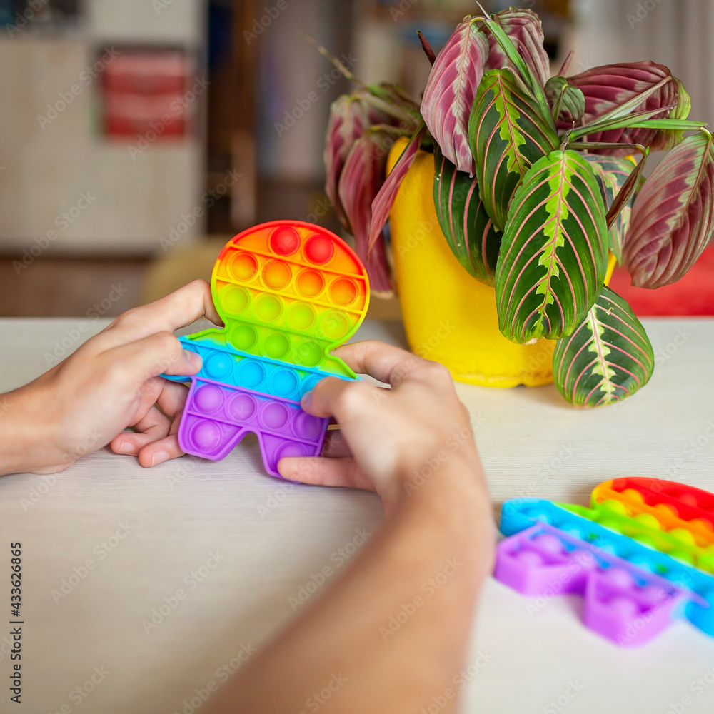 Young man playing with fidget sensory toy to relieve stress, simple way ...