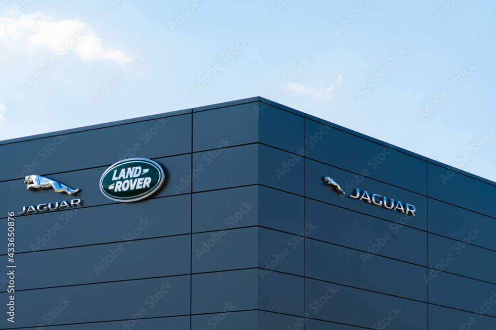 Jaguar Land Rover brand logo sign near oficial dealer office showroom ...