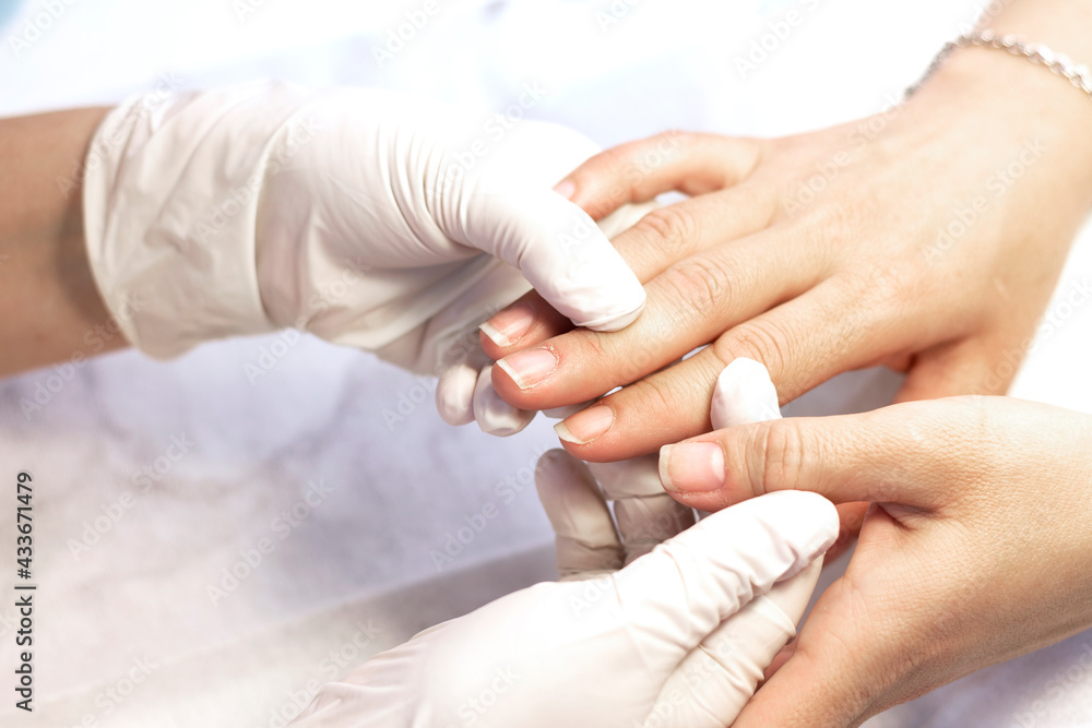 Examination and disinfection of the client's hands by a manicure master ...