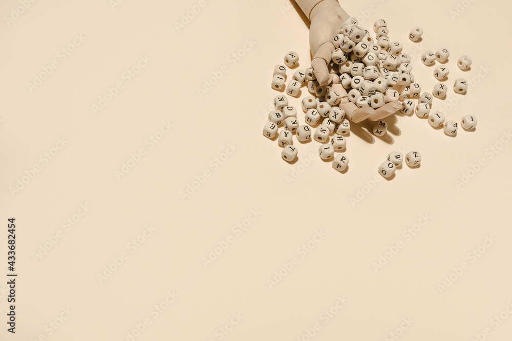 Top view of wooden hand with pile of alphabet letters on cubes ...