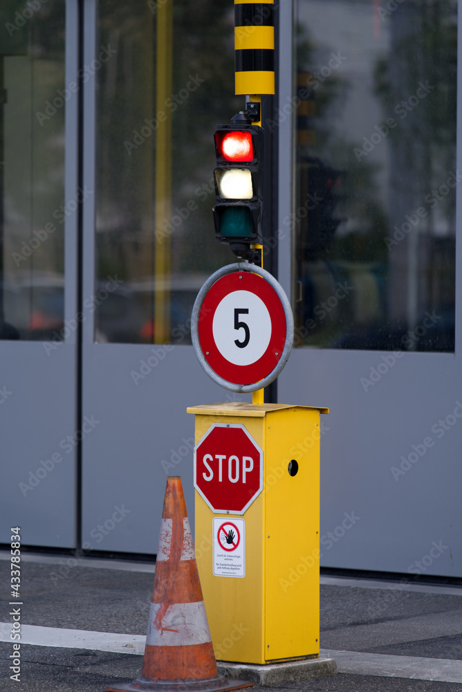 Road signs and traffic light at entrance gate of bus depot of public ...