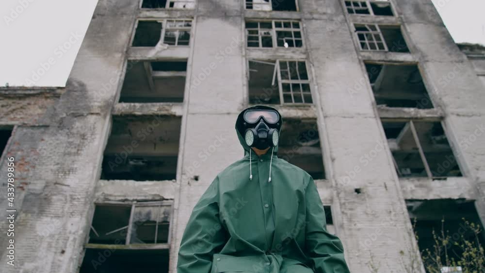 Portrait of a man in safety suit in radiation zone. Person in gas mask ...