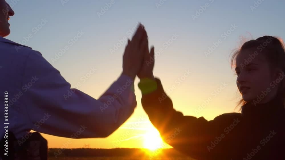 hands of young women mother and daughter giving high fives at sunset ...
