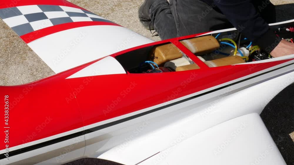 A model aircraft pilot repairing a small plane failure before take off ...