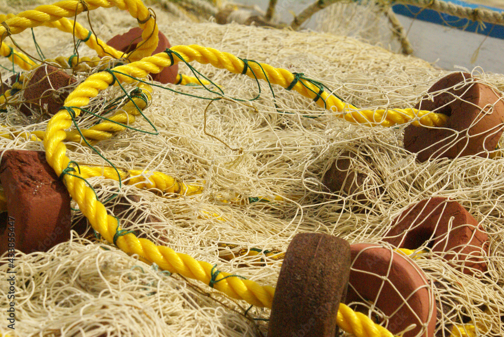 Redes de pesca en reposo frente al mar sobre la area de una playa Stock ...