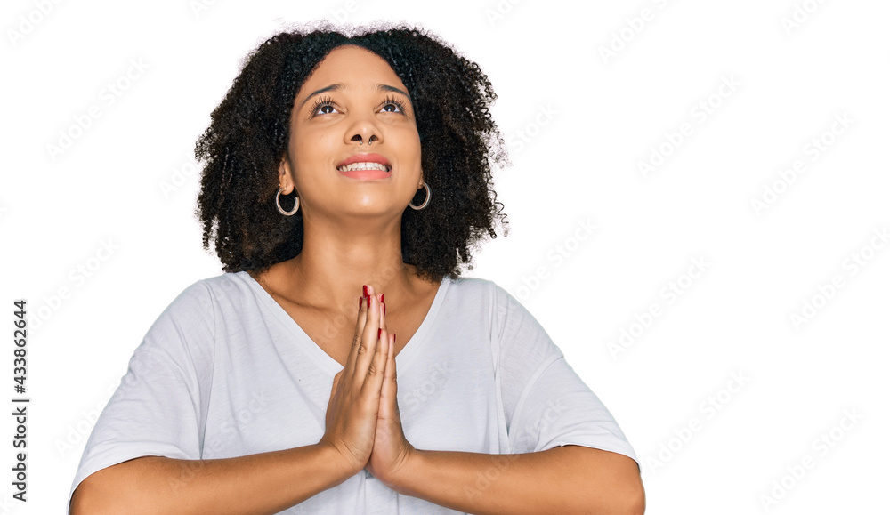Young african american girl wearing casual clothes begging and praying ...