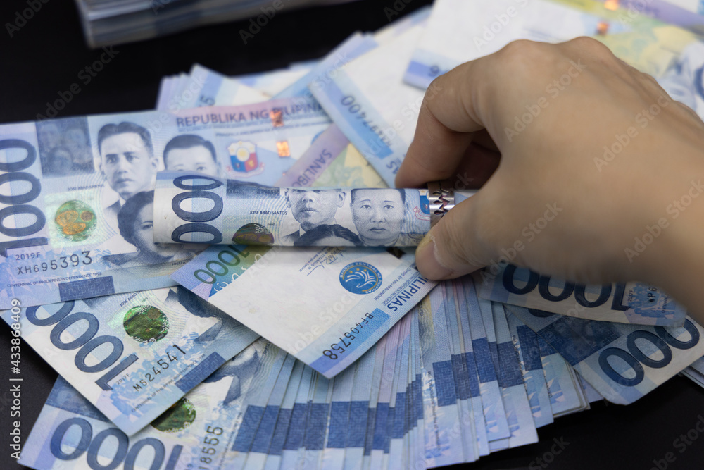 A pile of one thousand Philippines peso banknotes. Cash of Thousand ...