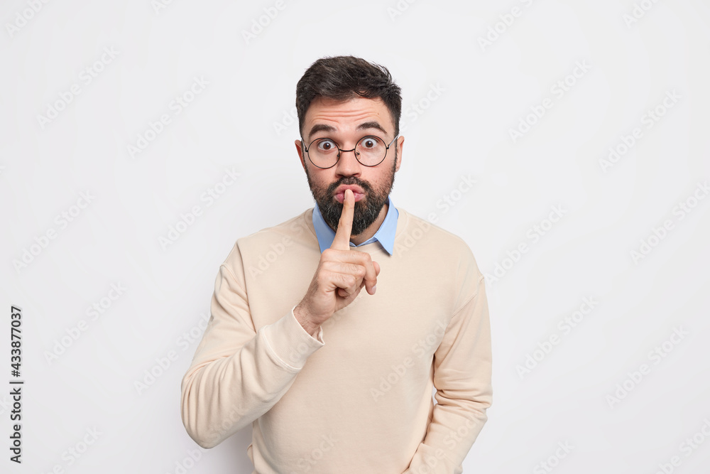 Hush do not say that. Surprised bearded man presses index finger to ...