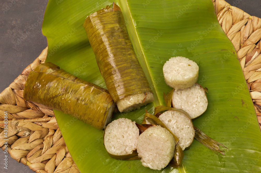 Malay traditional food called as Lemang. Glutinous rice is wrapped with ...