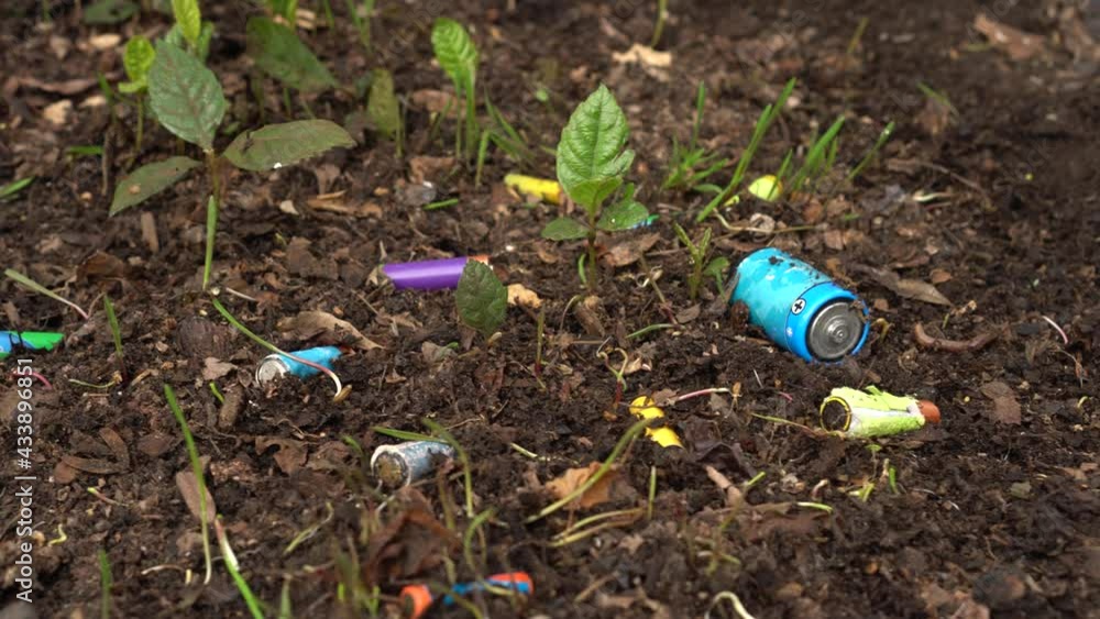 Dumping old batteries in landfills. Improper battery disposal. Soil and ...