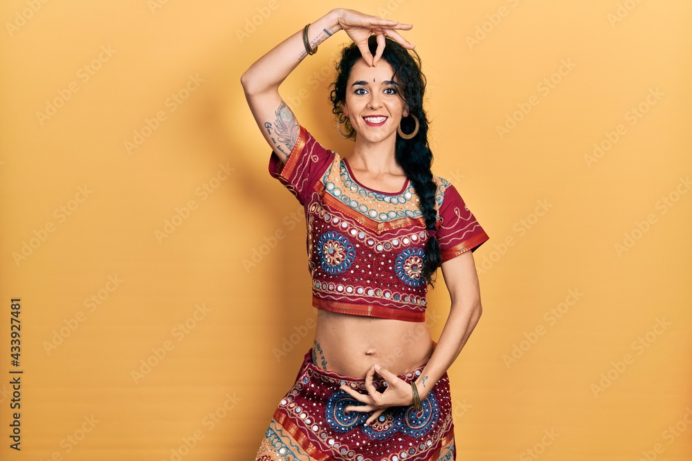 Young indian woman wearing traditional belly dancer costume. Dancing ...