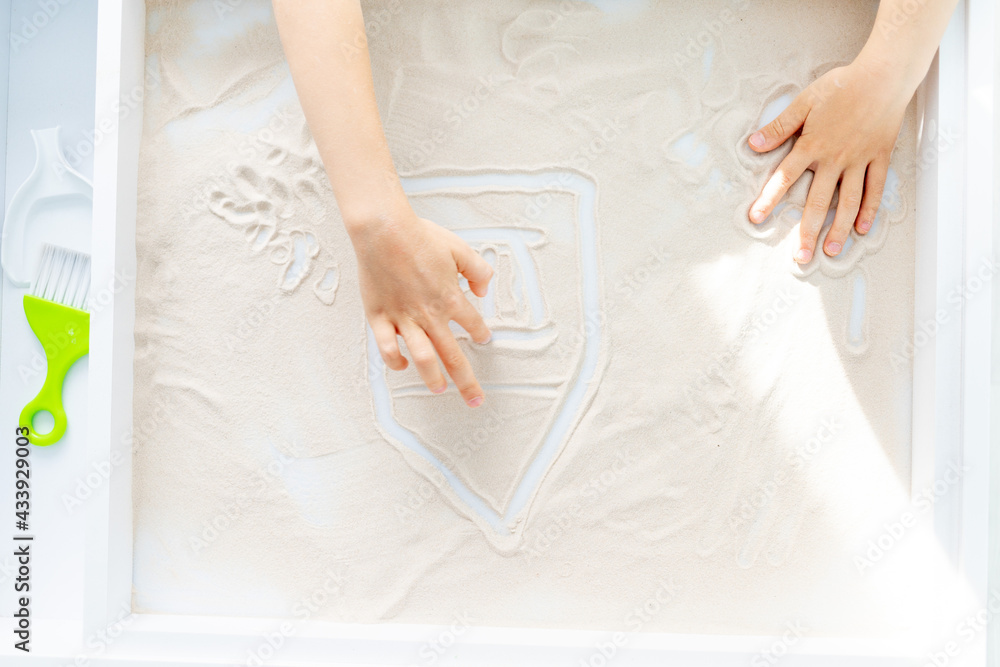 hands of a child drawing a house in the sand Stock Photo | Adobe Stock