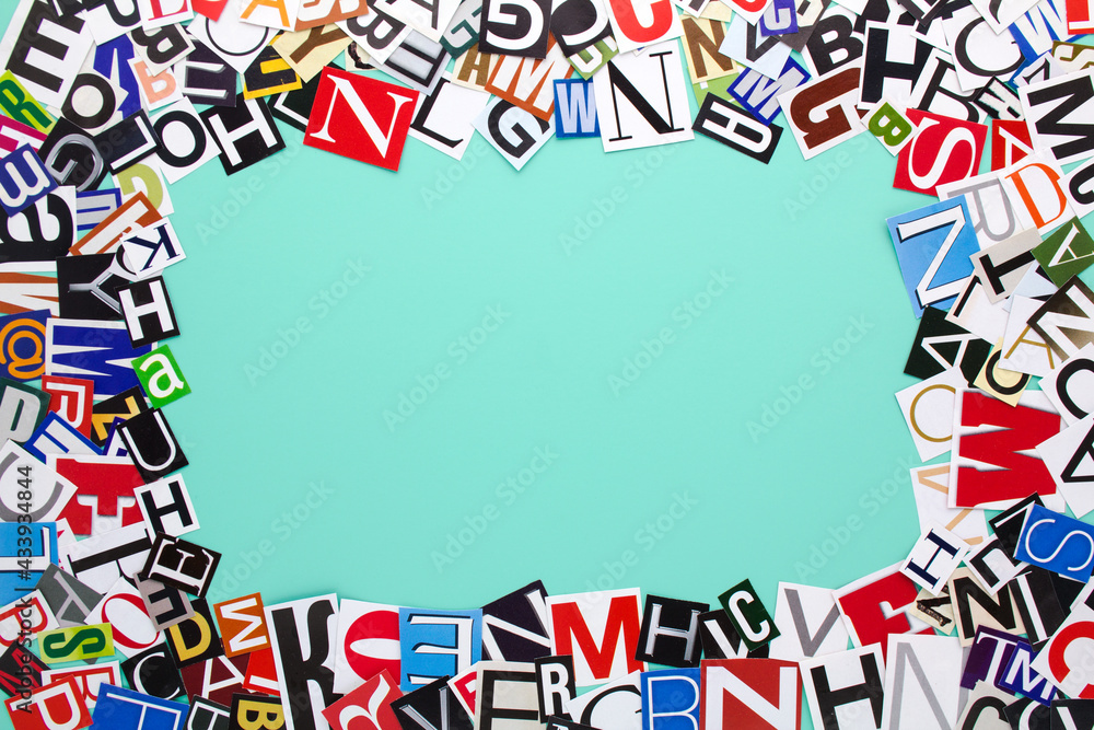 Alphabet letters cutting from paper magazine on azure green background ...