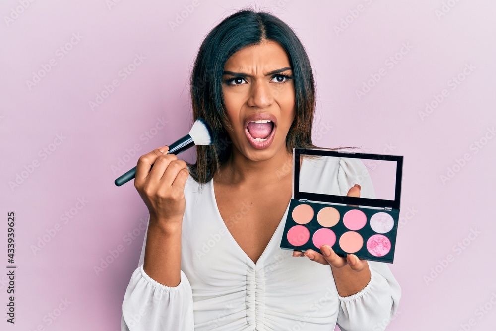 Young Latin Transsexual Transgender Woman Holding Makeup Brush And