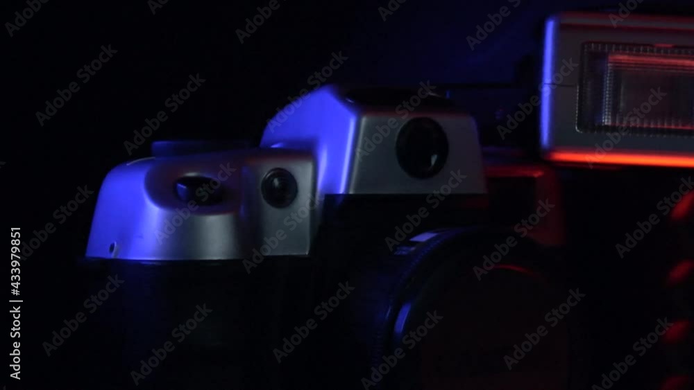 Vintage old analog photo camera with the flash and on a black ...