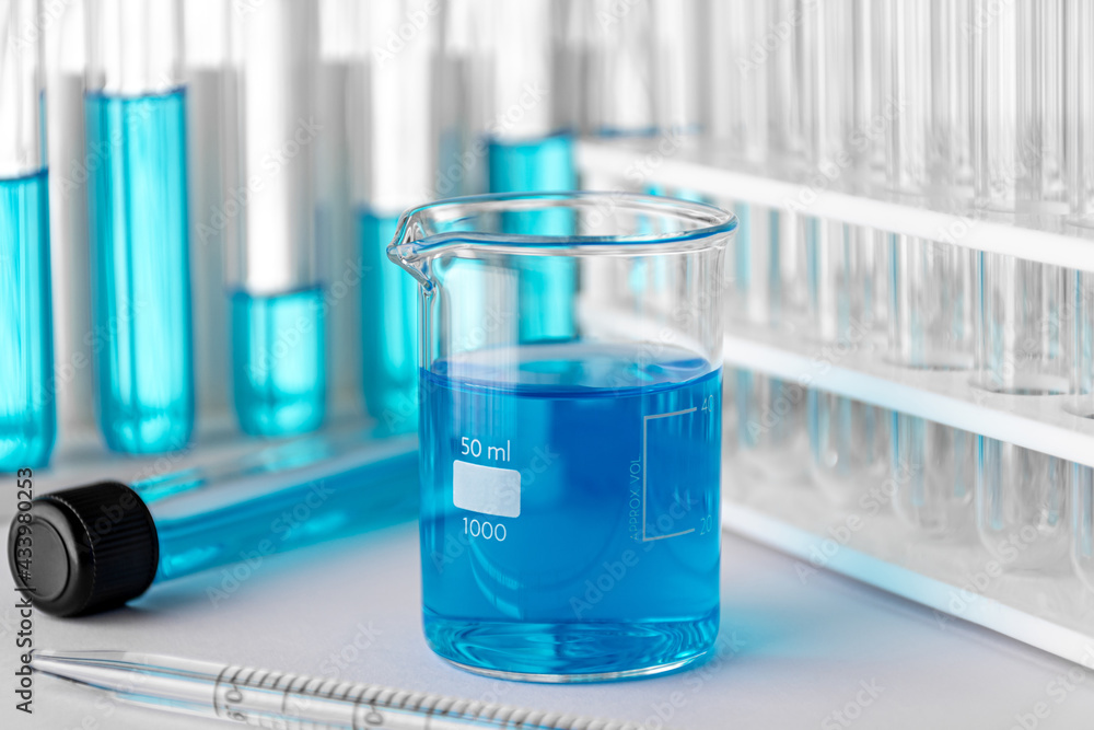 Test tubes and beaker in science lab Stock Photo | Adobe Stock