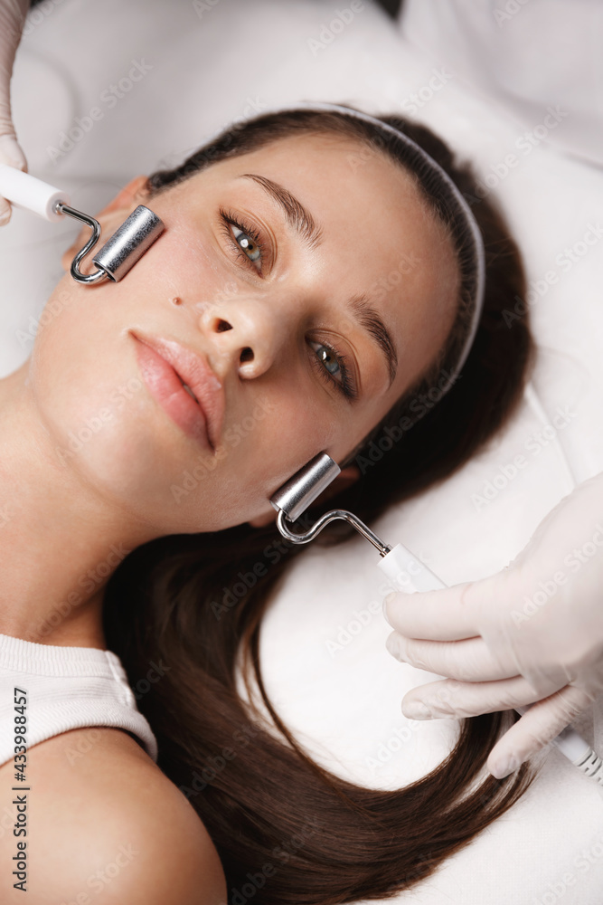 Woman beauty face with galvanic gel, female patient receives galvanic ...