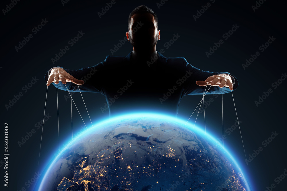 A man, a puppeteer, manipulates the planet. The concept of world ...