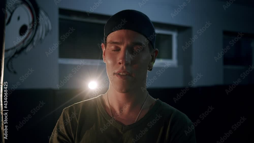 Portrait shot of handsome Caucasian young man turning face to camera ...