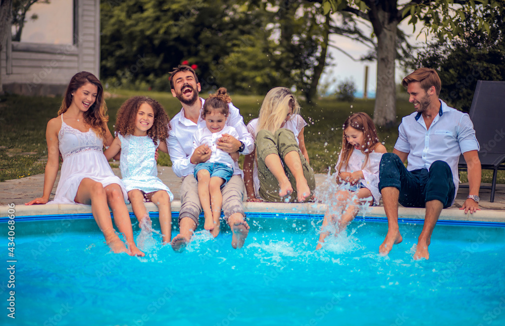 Large group of people sitting by the swimming pool. Stock Photo | Adobe ...