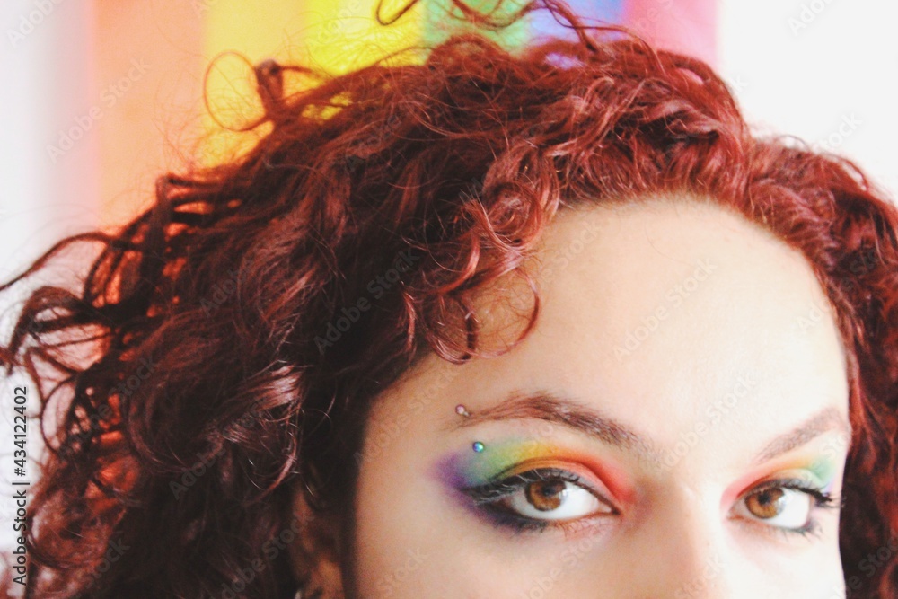 bright closeup portrait of queer young womans eye makeup of lgbtqia+ ...