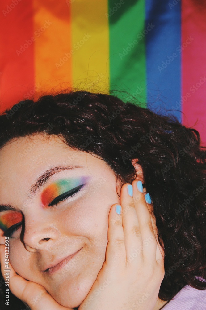 closeup smiling happy portrait of queer young woman with lgbtqia+ pride ...
