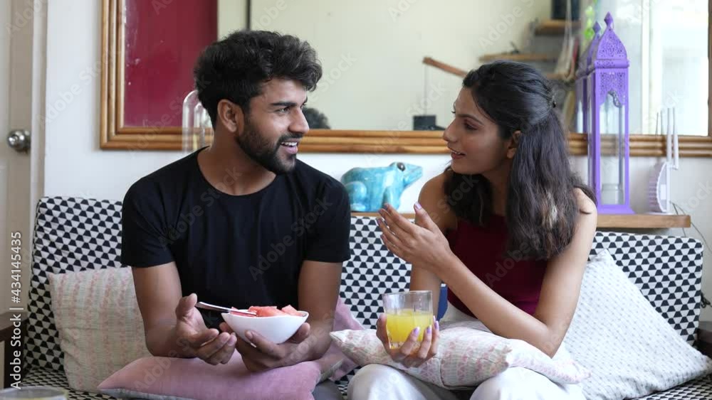 Two Indian friends having happy talks and laughing together while ...