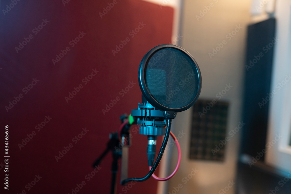 Pop filter and modern dynamic mic with wires in empty sound studio on ...