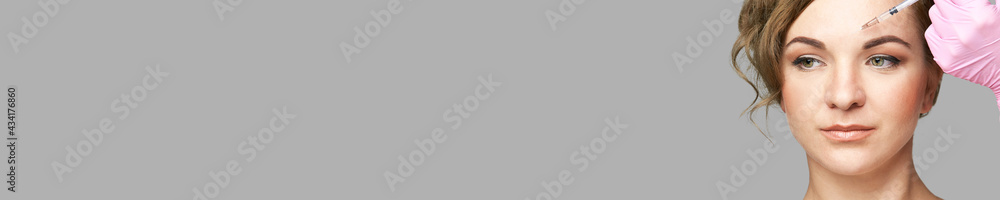 Face needle injection. Young woman cosmetology procedure. Doctor hand ...