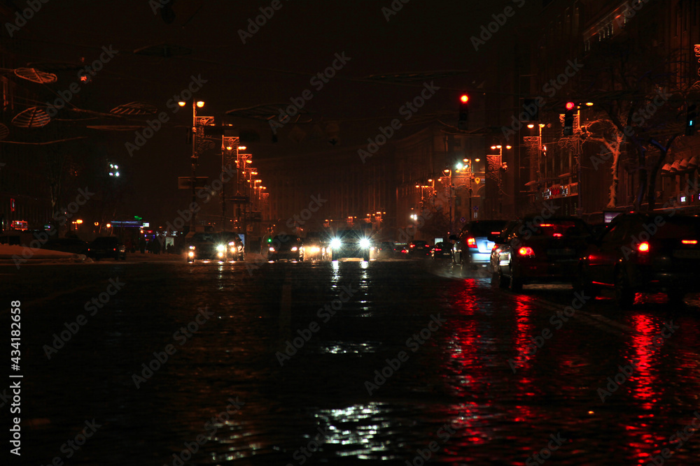 Main street at night. Night city lights. Car headlights on the night ...