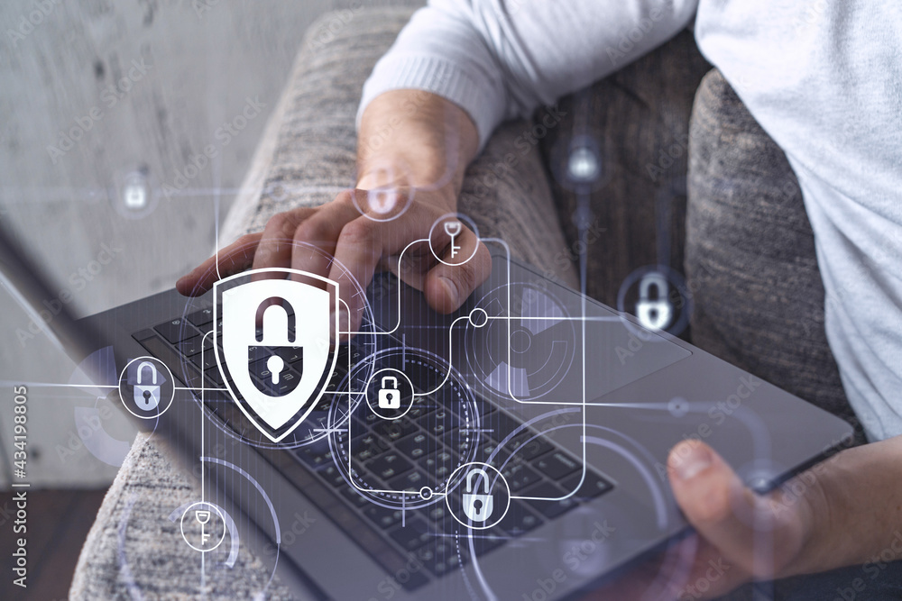 A programmer is typing a code on a keyboard to protect a cyber security from hacker attacks and ...