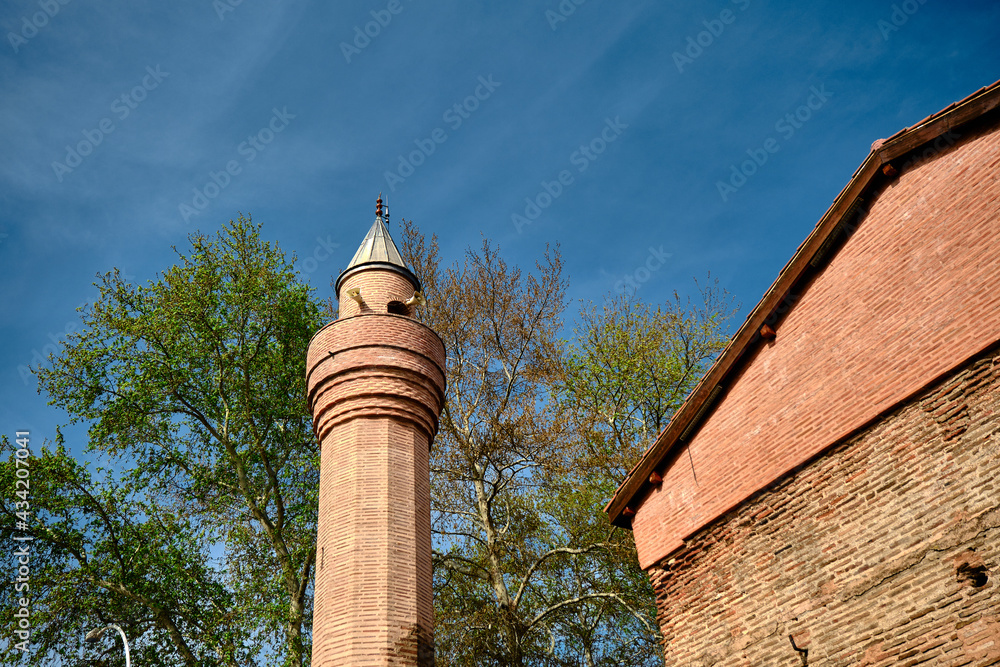 Minaret made of red bricks and tree in Bursa, Nicaea (iznik), Turkey ...