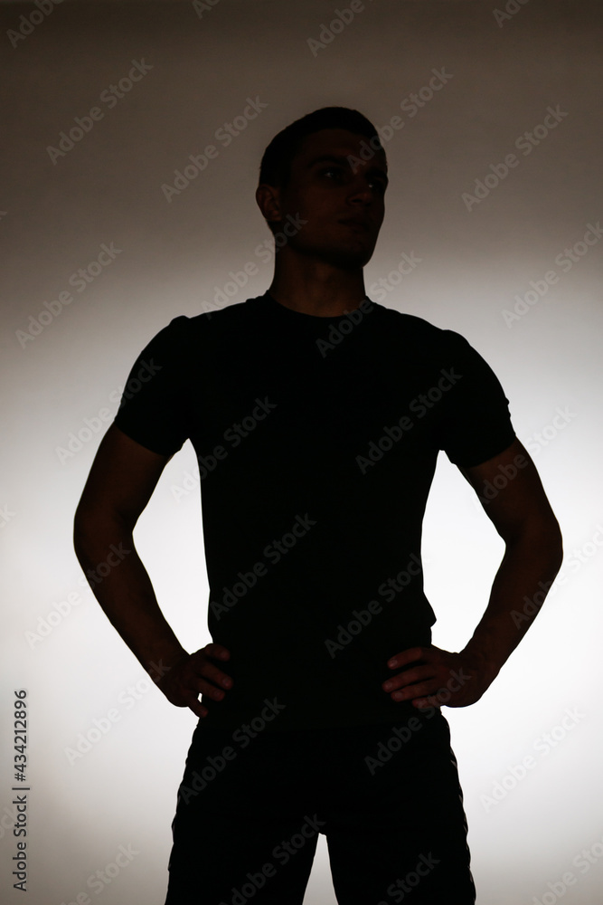 Dark silhouette of a strong man body on white background. Confident ...