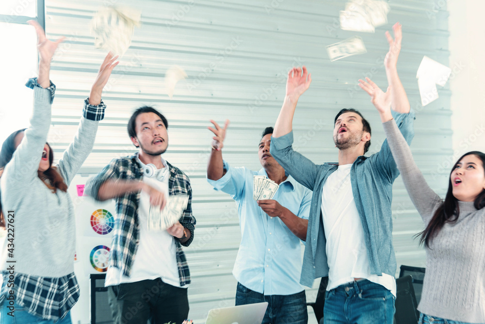 Happy business people holding dollar money and throw in the air ...