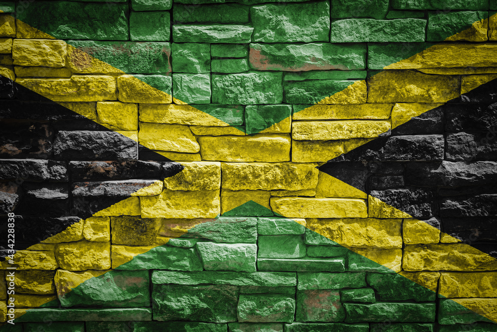 National flag of Jamaica on stone wall background.The concept of ...