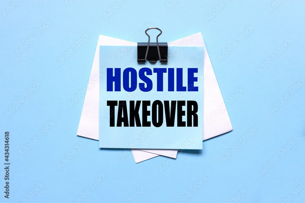 hostile takeover.stickers are clamped. on a blue background. black ...