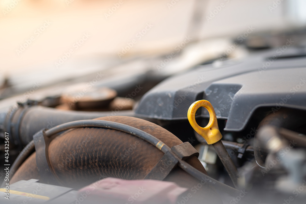 A motor engine oil level indicator dipstick with yellow handle hook ...