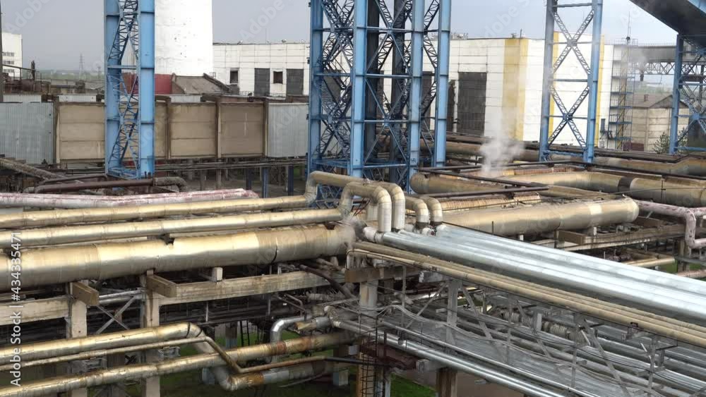 The territory of a large factory. huge, industrial pipes in a factory ...