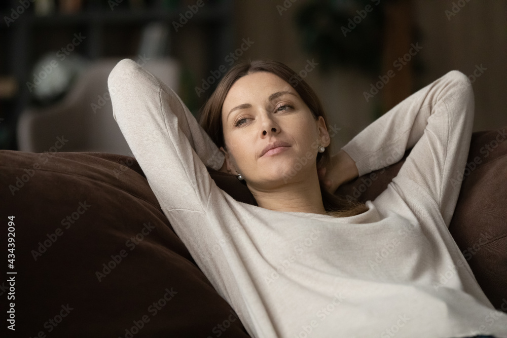 No need to hurry. Tranquil teenage female enjoy rest at home lie on ...