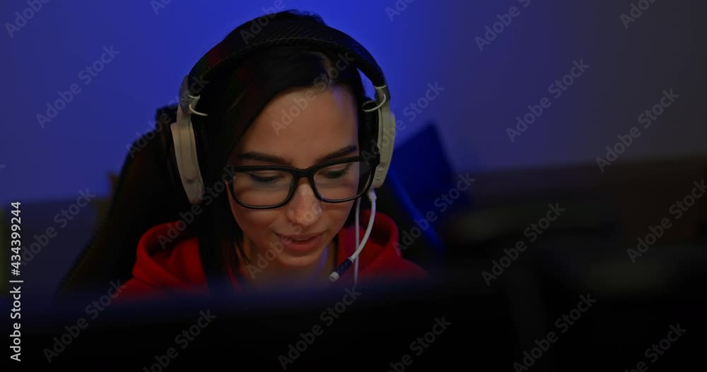 Portrait, cute girl blogger looks at the monitor screen and smiles, she ...