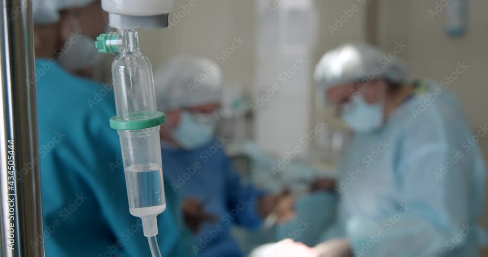 During the operation, the patient is injected with saline through a ...