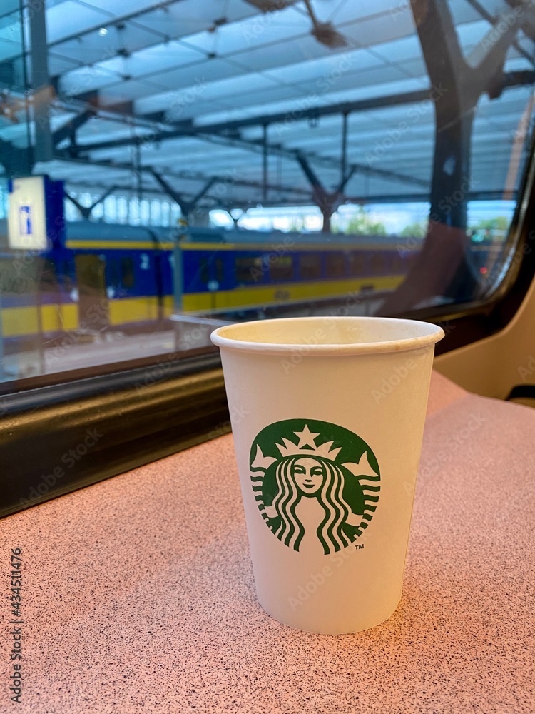 Coffee to go commuting to work on the NS train waiting at the platform ...